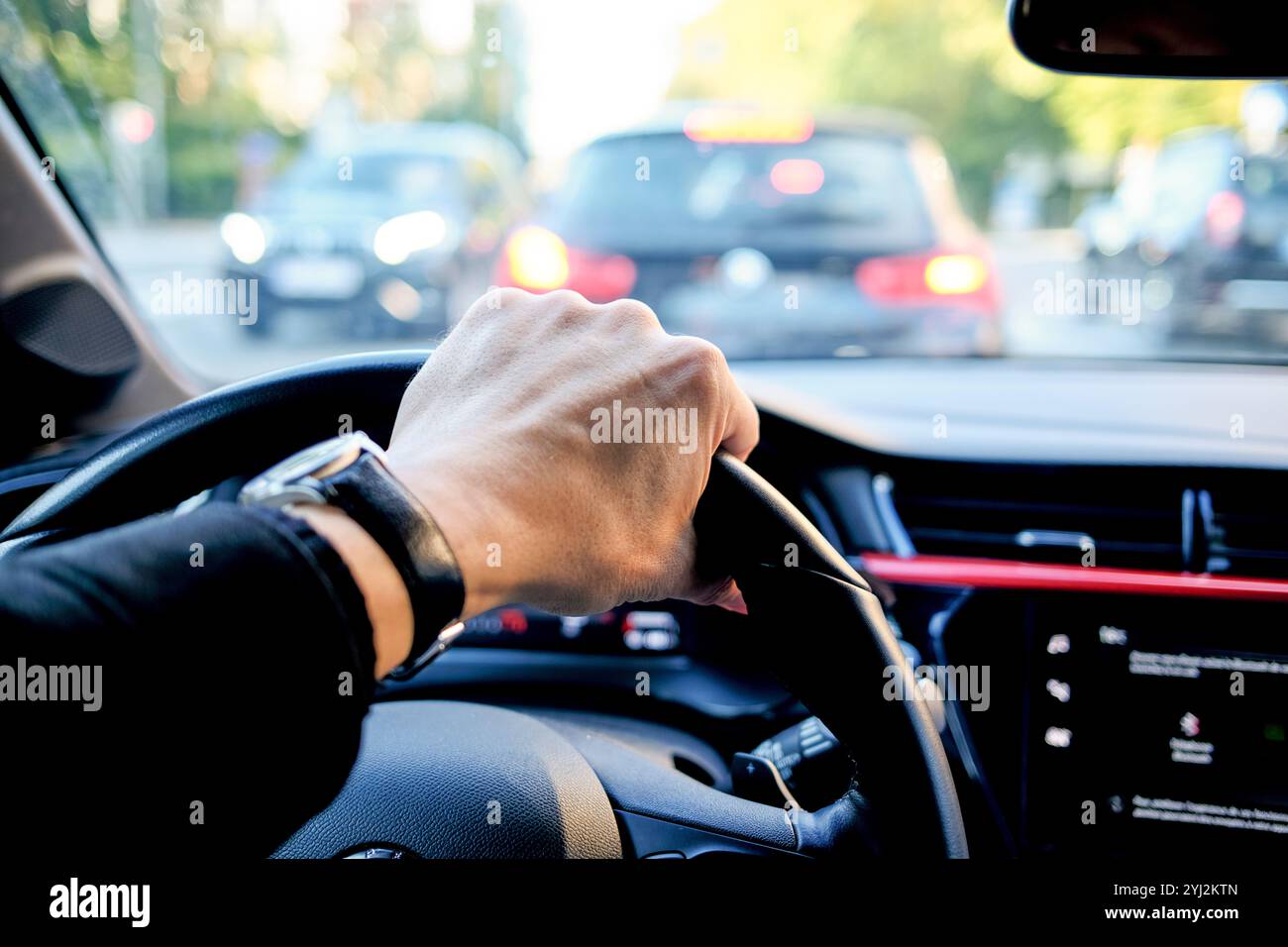 Driver's hand on the steering wheel of a car during a traffic jam Stock ...