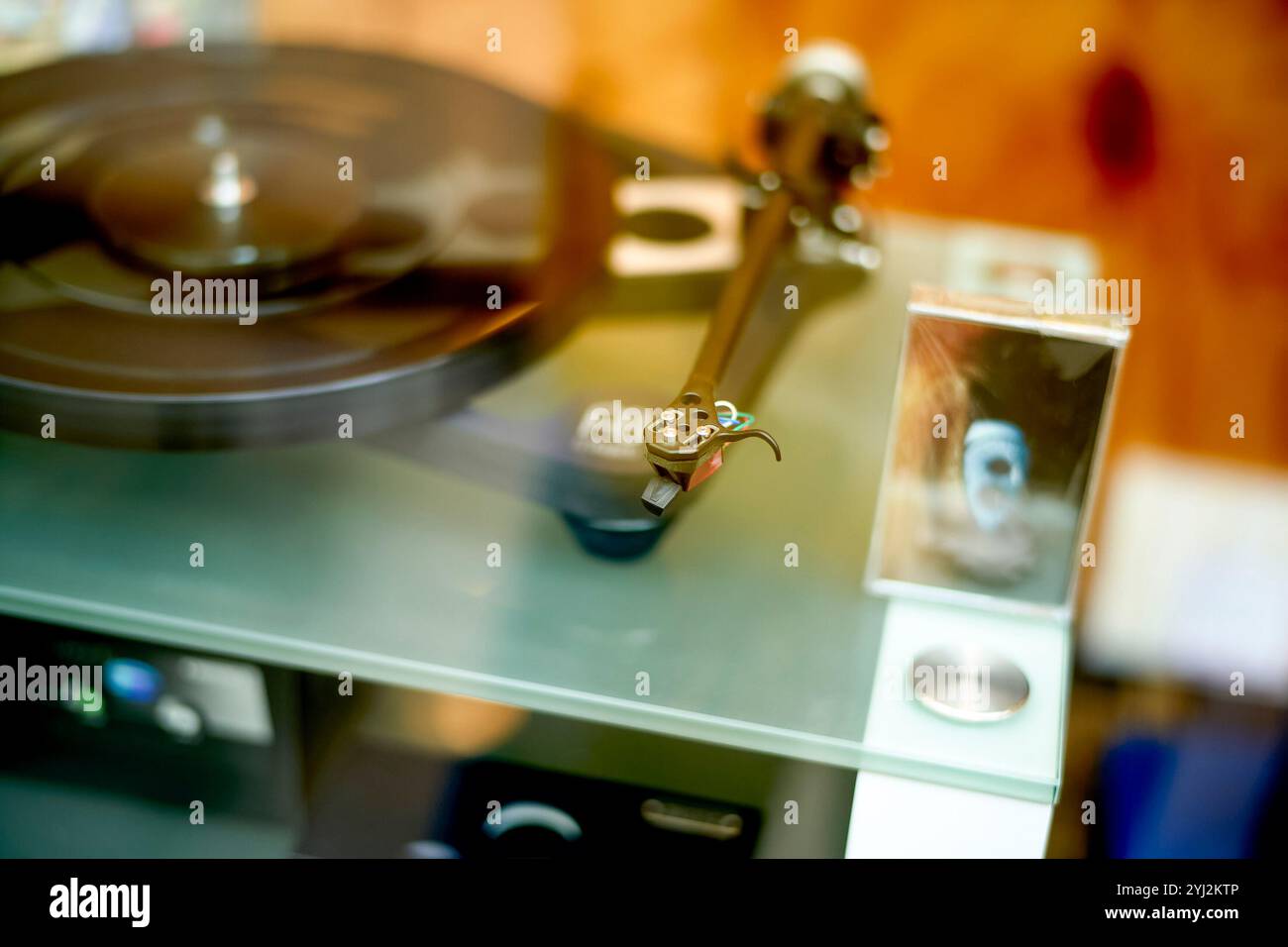 Vintage turntable with vinyl record and stylus needle, with a blurred ...