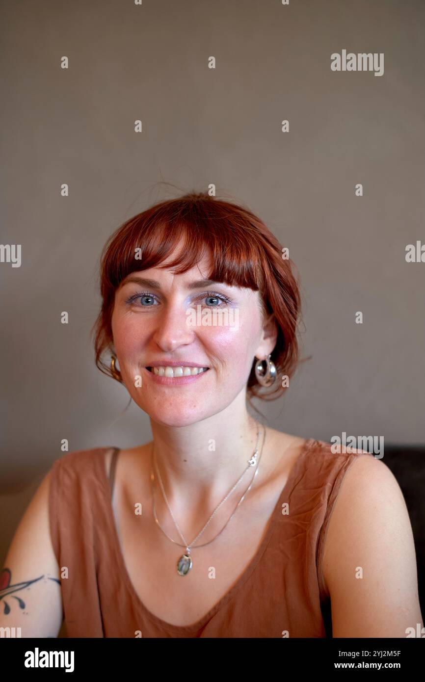 Smiling woman bangs tattoo arm hi-res stock photography and images - Alamy