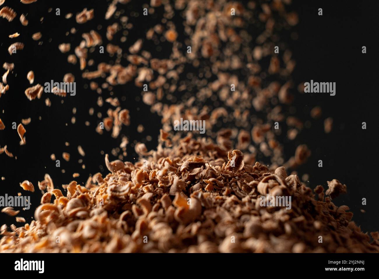 Shredded natural organic chocolate pour on black background Stock Photo ...