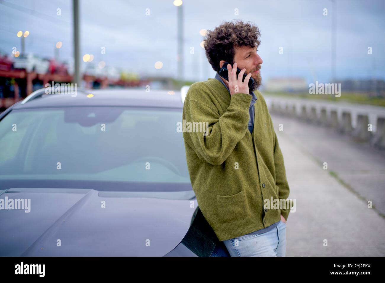 Man talking mobile phone leaning car roadside hi-res stock photography ...