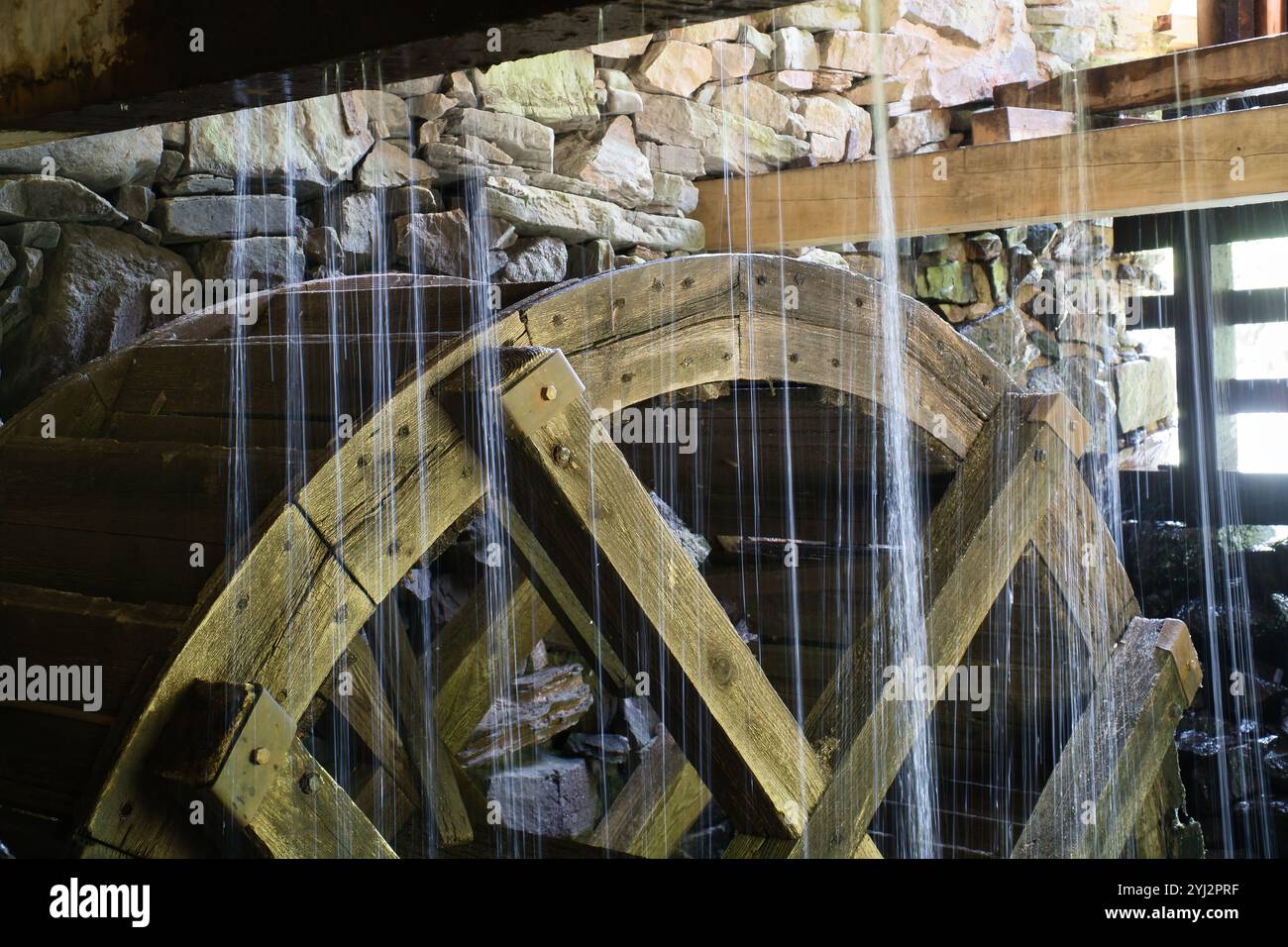Old wooden waterwheel splashed by falling water. Picture from a ...
