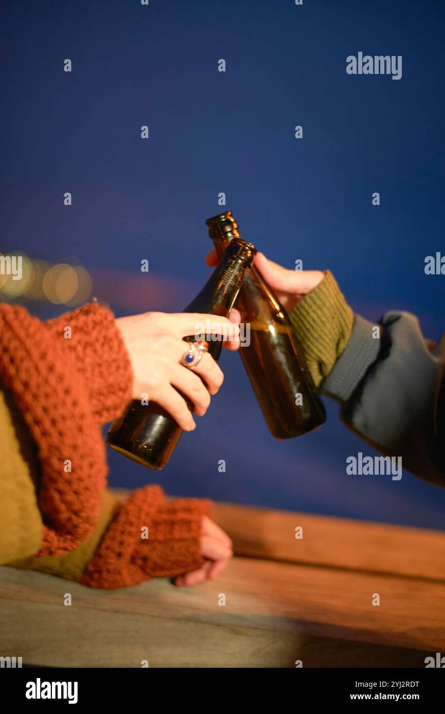 Two beer bottles clinking together hi-res stock photography and images ...