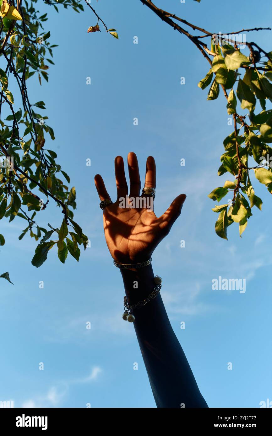 Black hand reaching to sky hi-res stock photography and images - Alamy