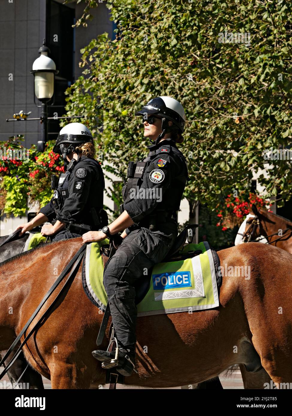 Toronto Canada / Mounted Policewomen water their horses, at the very ...