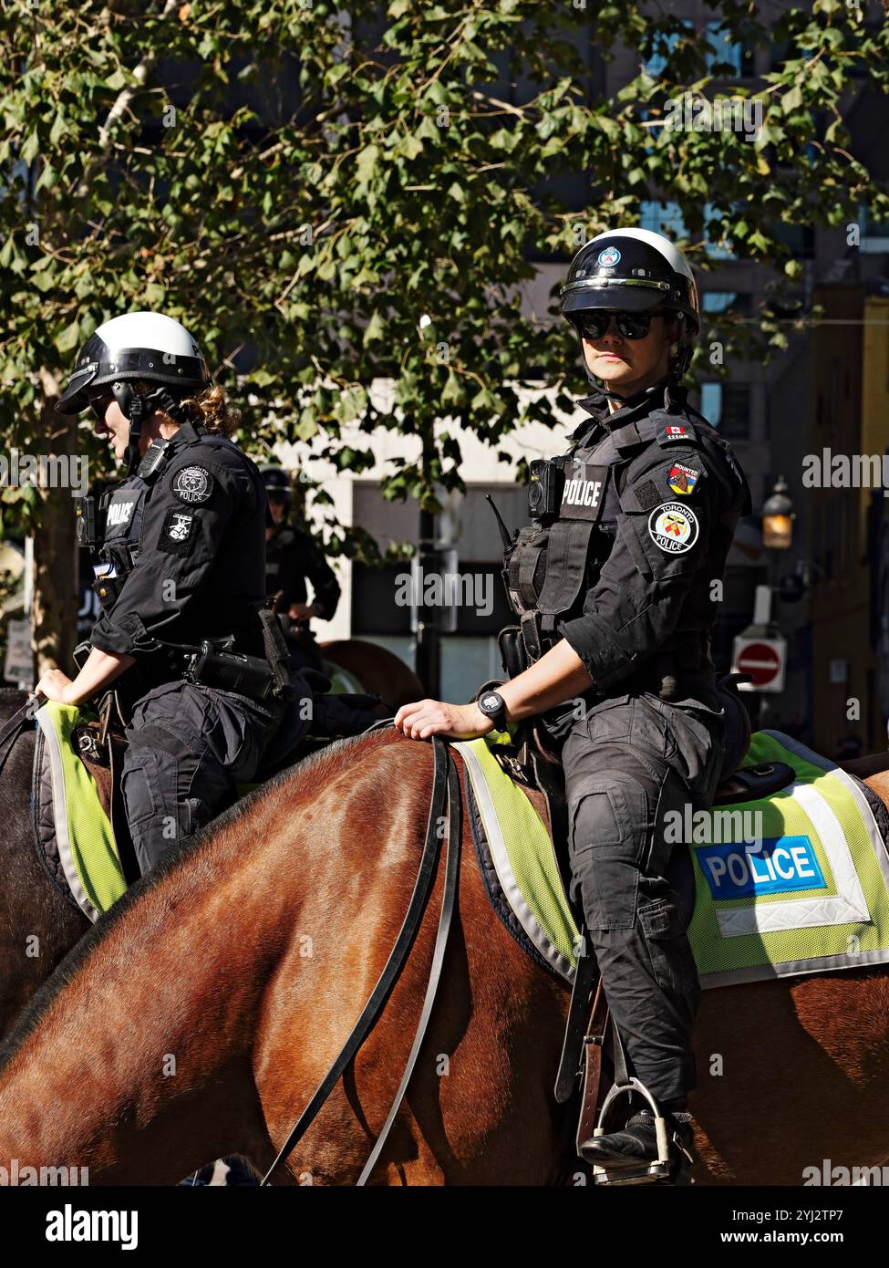 Toronto Canada / Mounted Policewomen water their horses, at the very ...