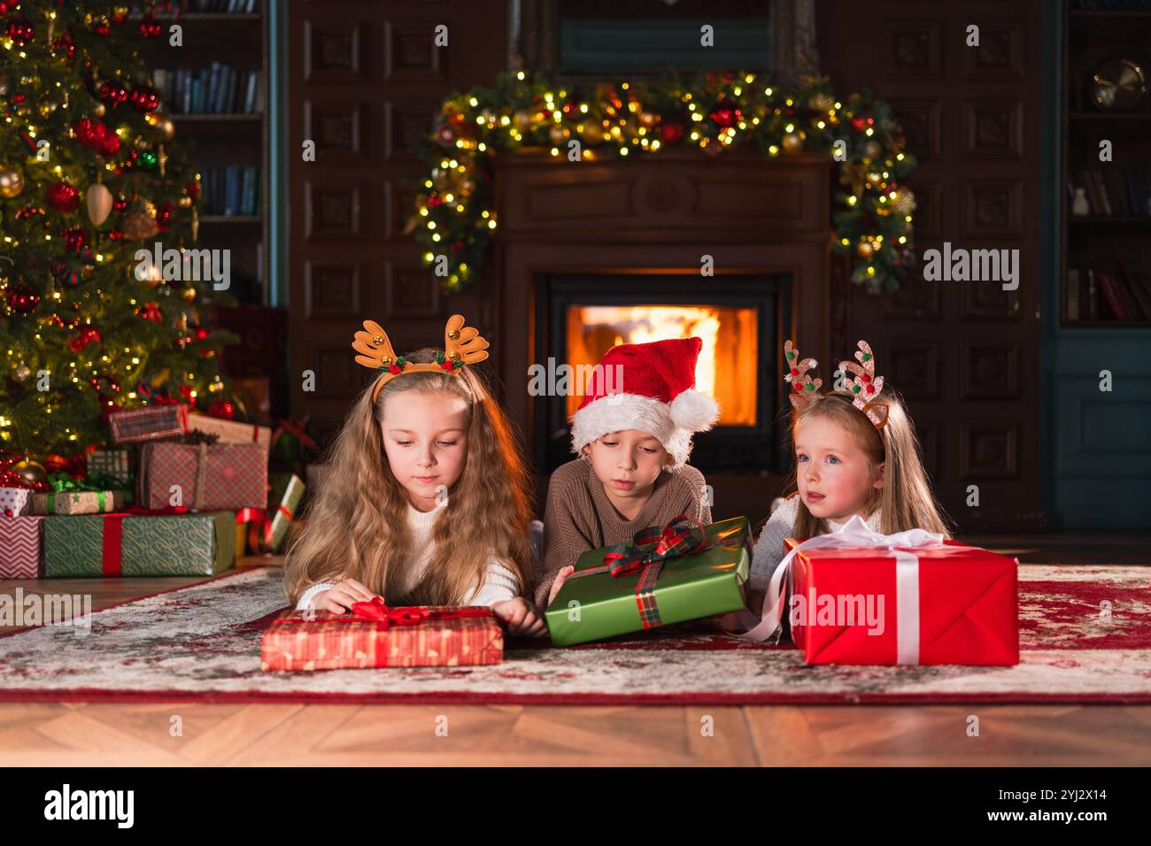 Merry Christmas Xmas holiday. Children unpacking open up gift box near ...