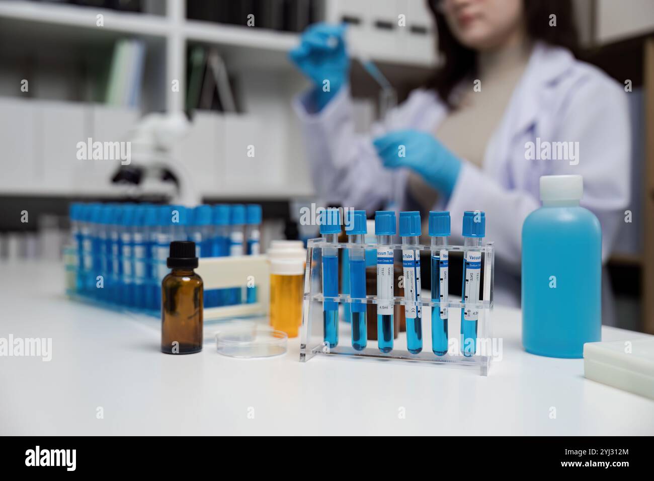 Modern Scientific Laboratory with Test Tubes and Researcher Conducting ...