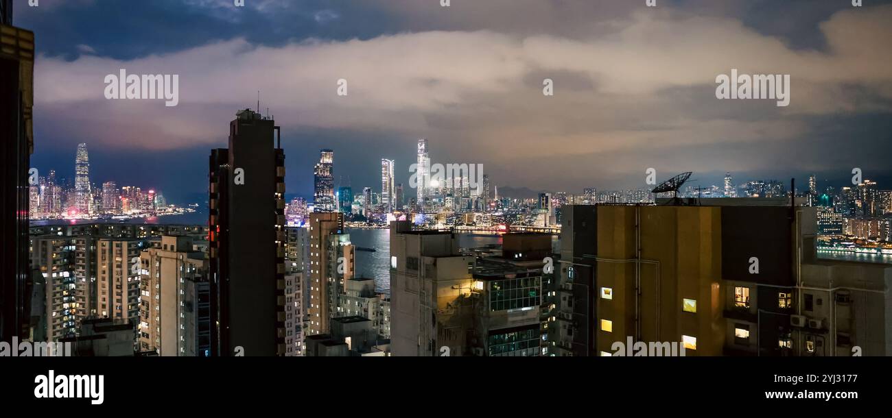 The vibrant skyline of Hong Kong showcases high-rise buildings lit up ...