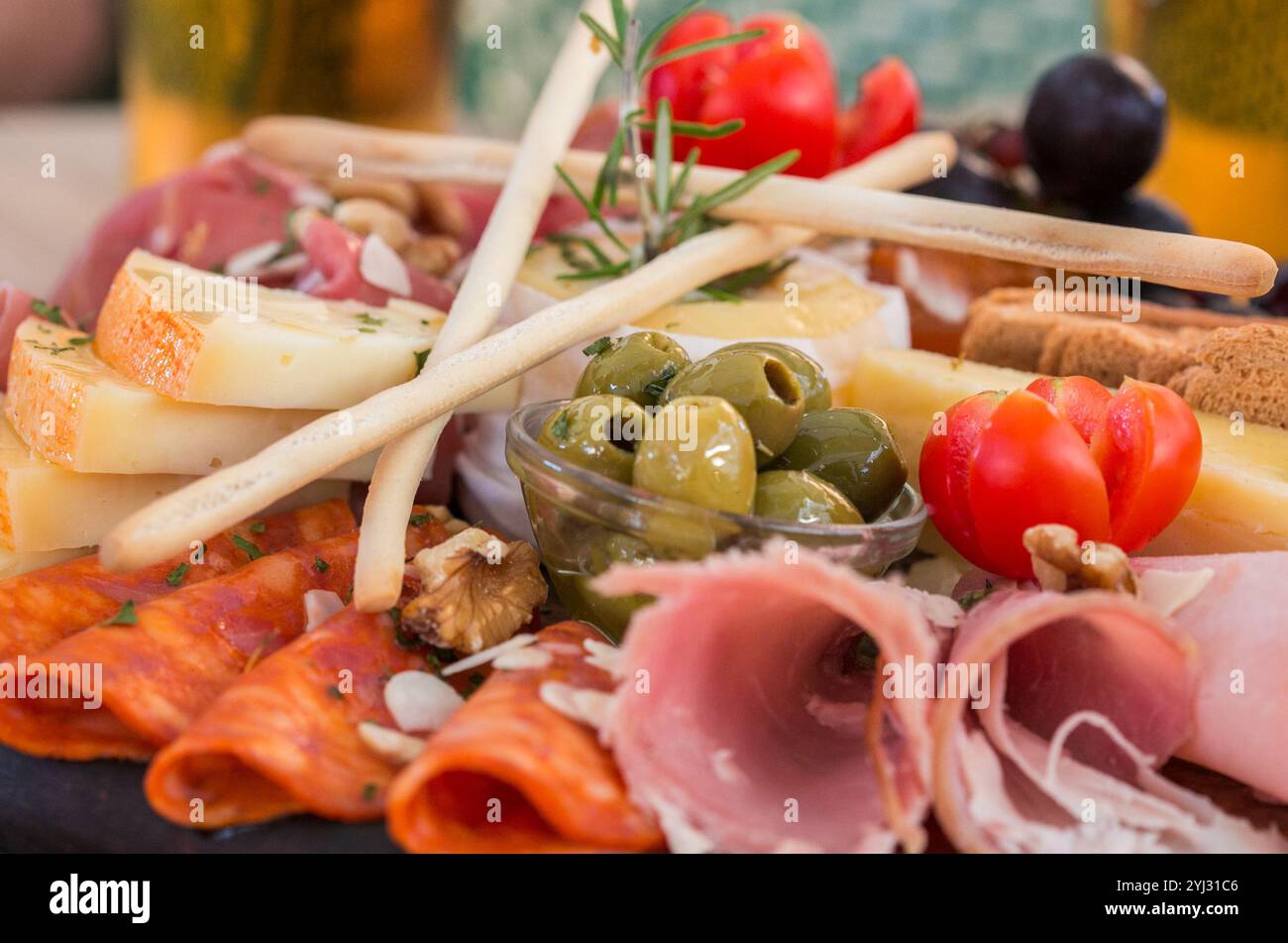 Portuguese charcuterie plate with ham, different cheeses and bread ...