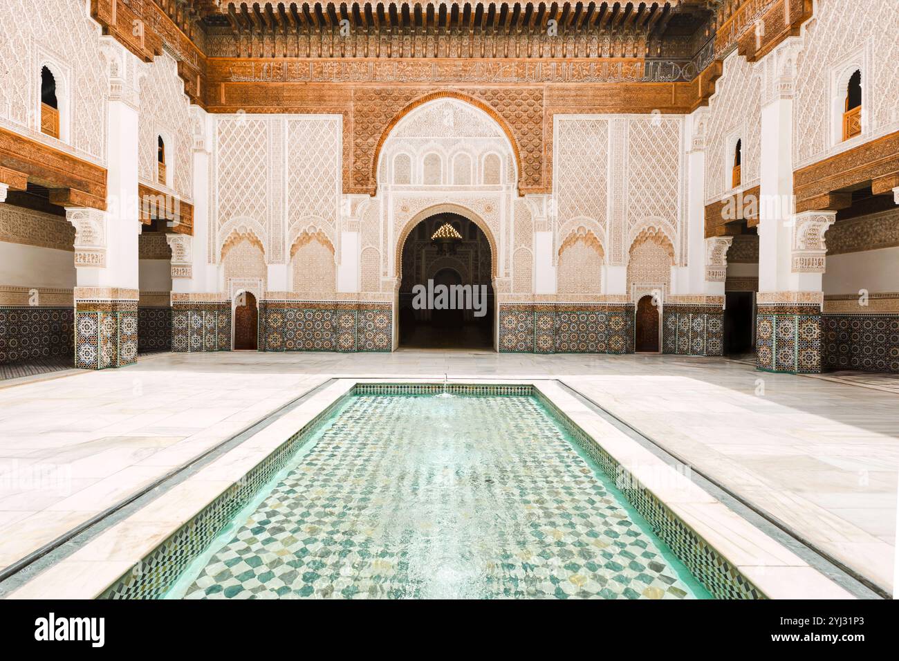 Ben Youssef Madrasa interior courtyard with intricate mosaic tiles and pool, traditional Islamic ...