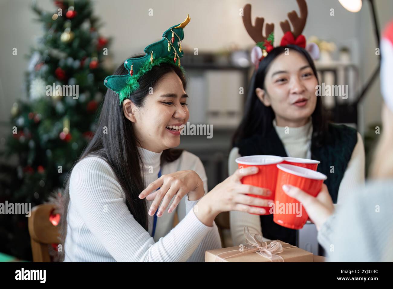 Festive Office Christmas Party Celebration with Colleagues Enjoying Drinks and Holiday Cheer in ...