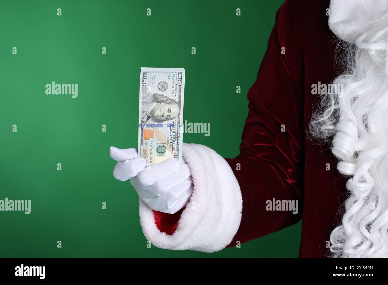 Santa Claus holding dollar banknotes on green background, closeup Stock ...