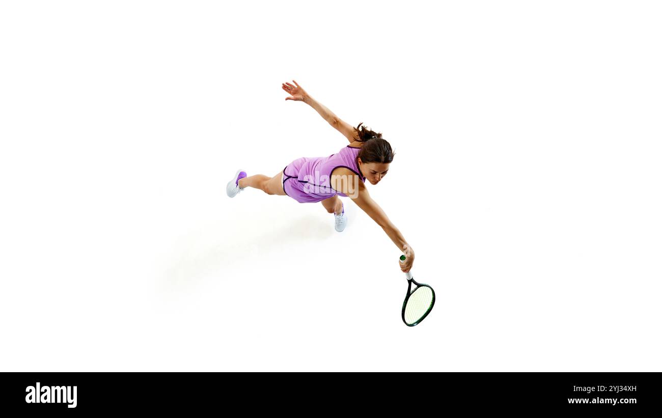 With determined gaze, tennis player holds her racket high, ready to ...