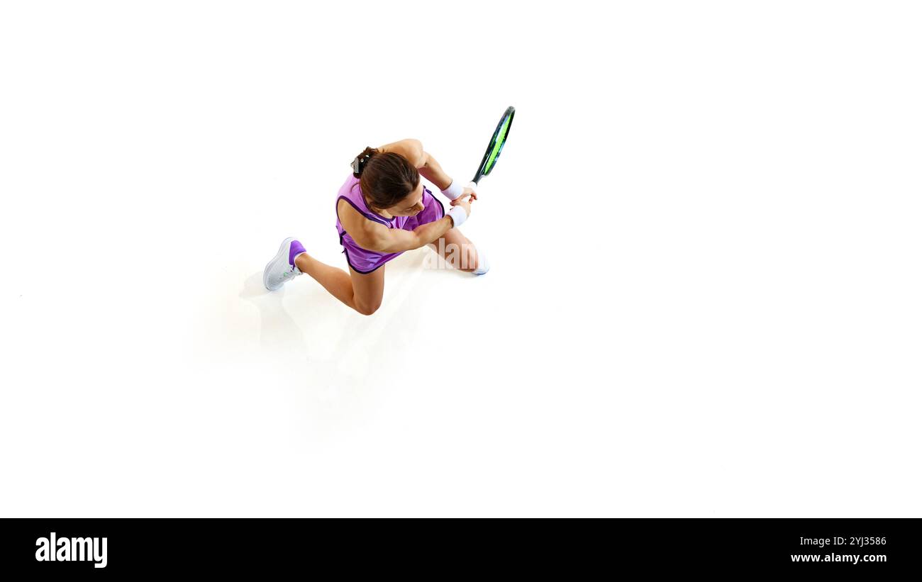 Focused, female tennis player in top-down shot, her eyes fixed on ball ...