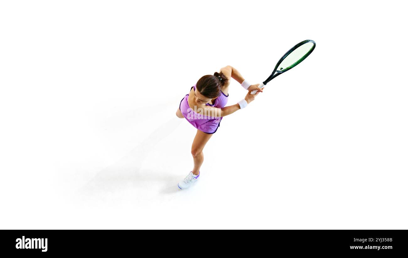 Focused, female tennis player in top-down shot, her eyes fixed on ball ...