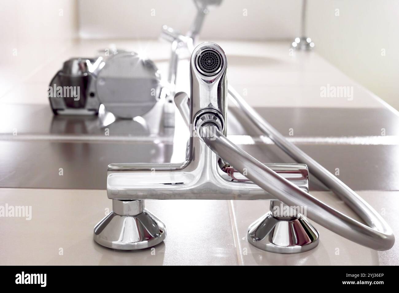 Modern designer tap and shower in bathroom Stock Photo - Alamy