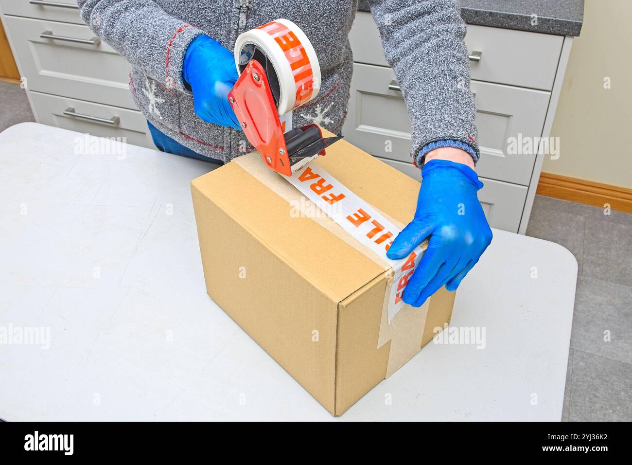 Woman packing cardboard parcel boxes hi-res stock photography and ...
