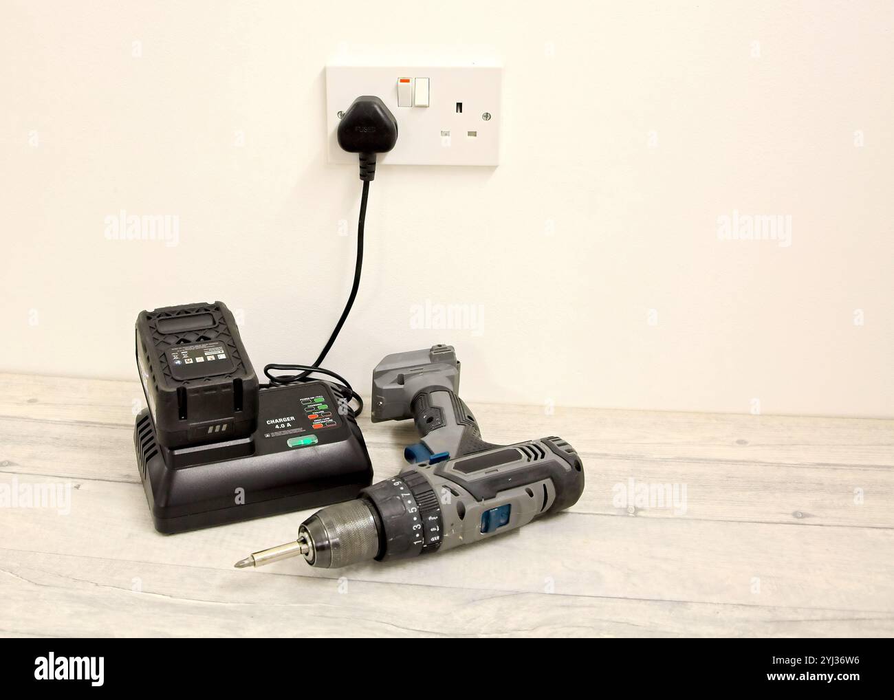 Battry chager plug into wall socket charging a battey with corless ...