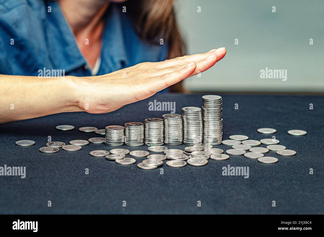 Female hand over coins in stacks. Symbol of profit growth, counting ...