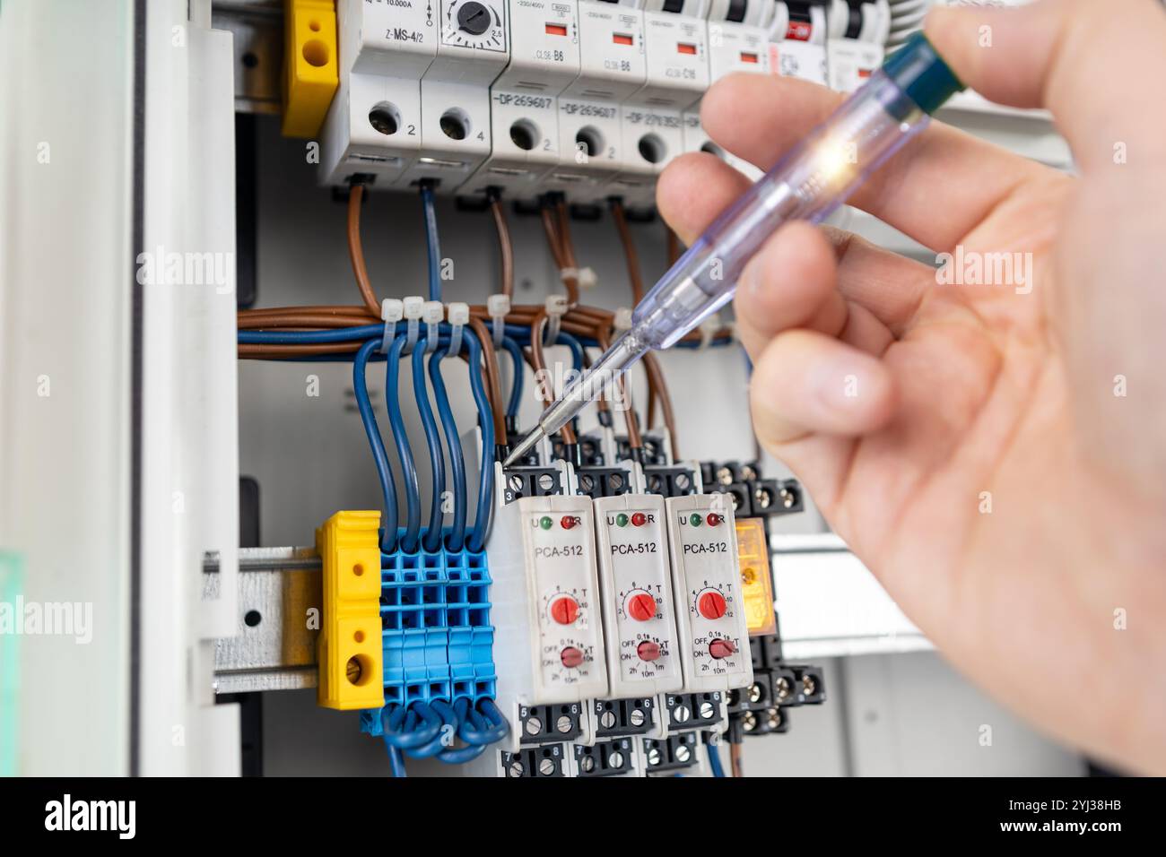 Electrician Testing Electrical Connections with Voltage Tester in ...