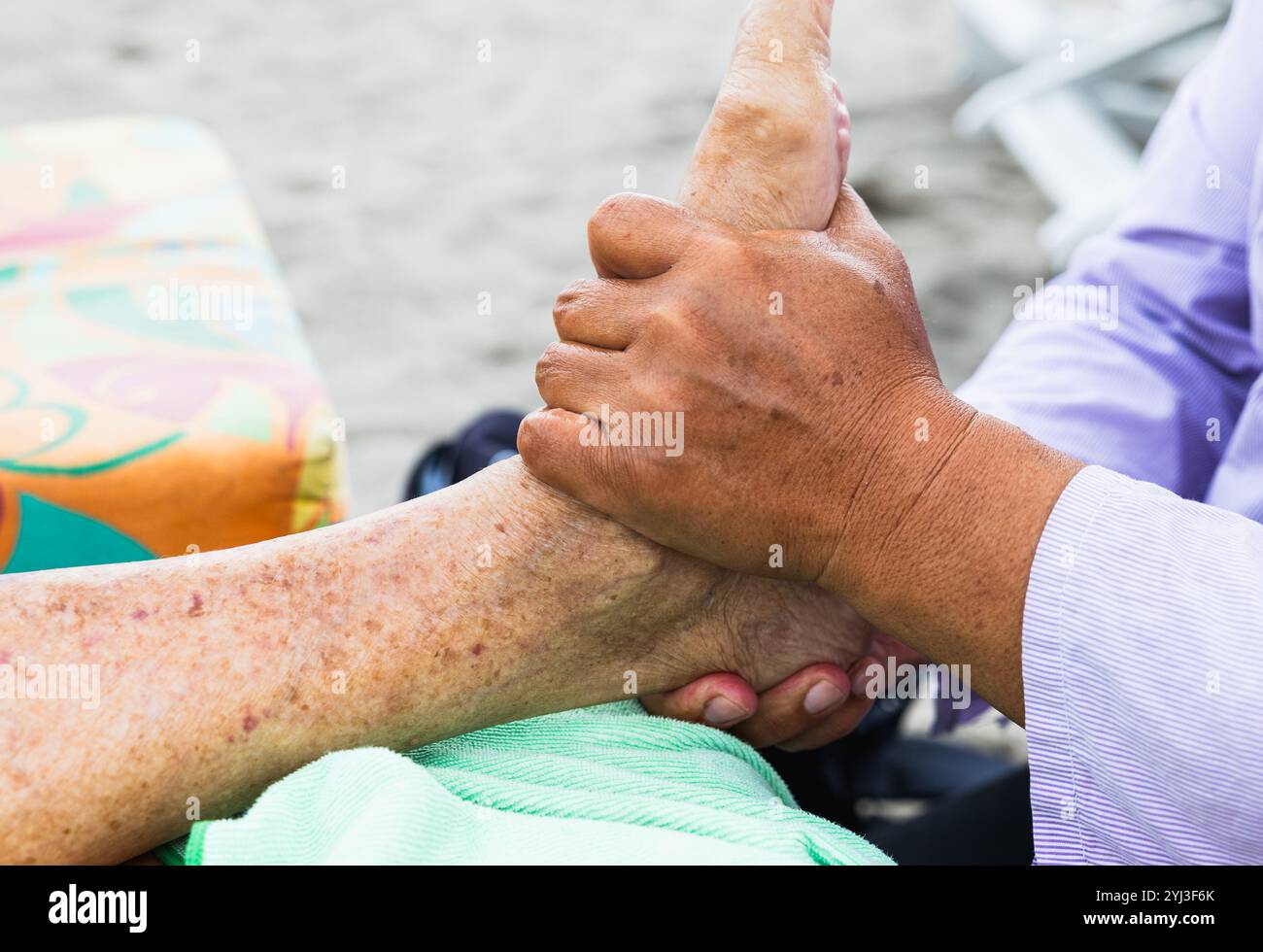 Hands providing therapeutic foot massage to an elderly woman Stock ...