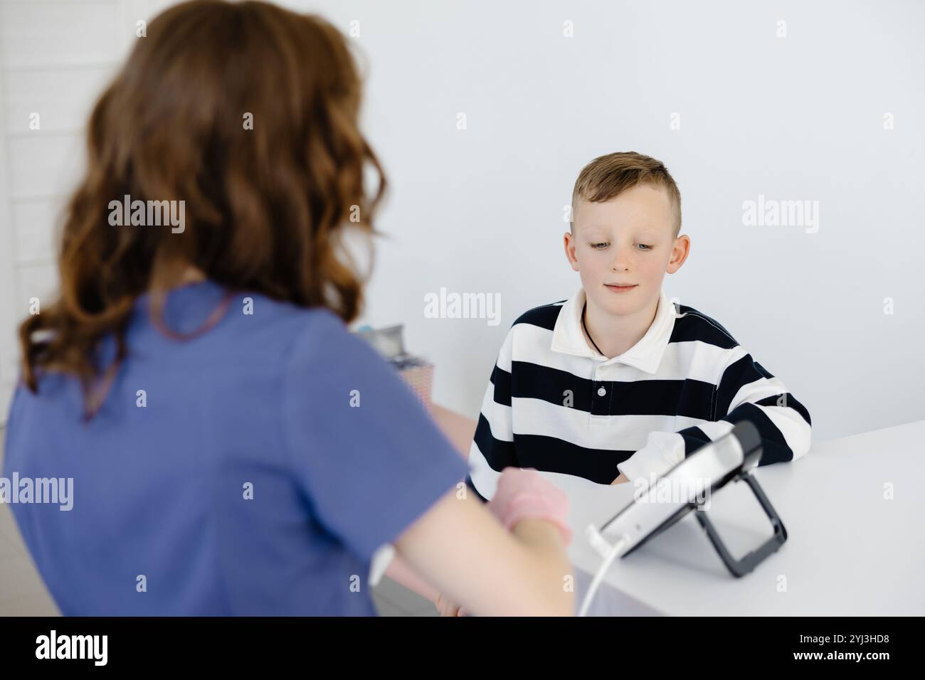 Boy testing breathing function by spirometry in doctors office ...