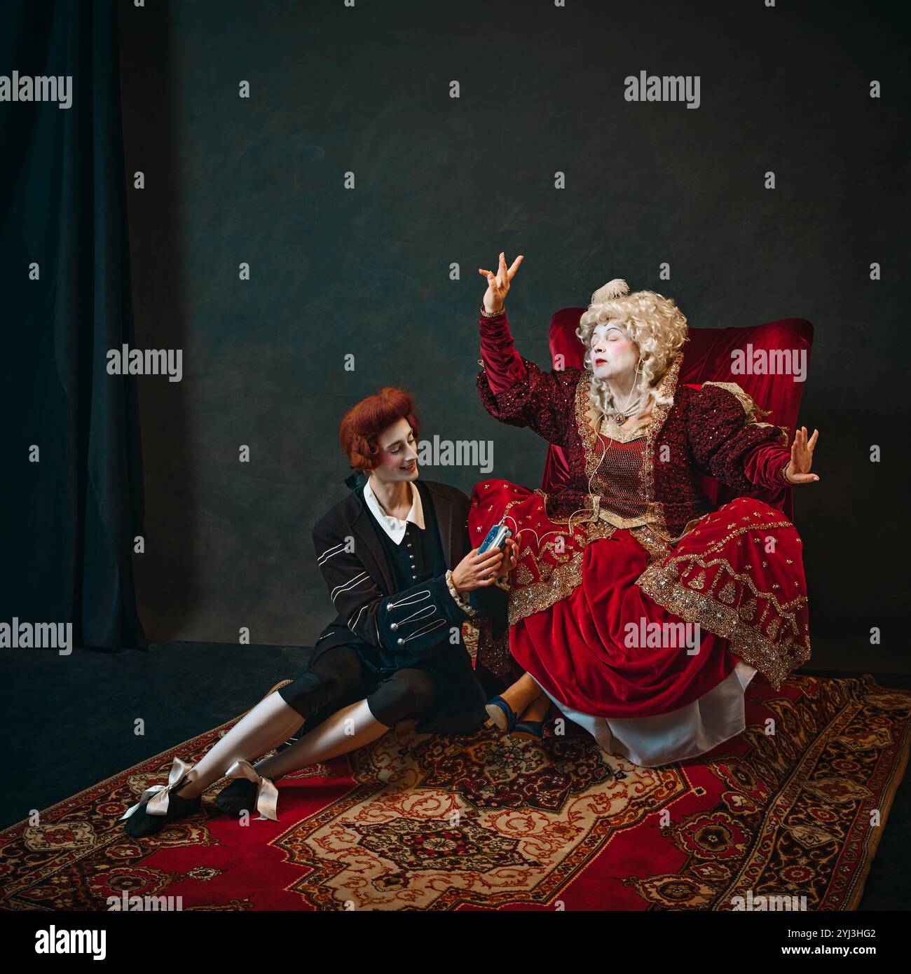 Elderly woman and young man against dark background. Medieval empress ...