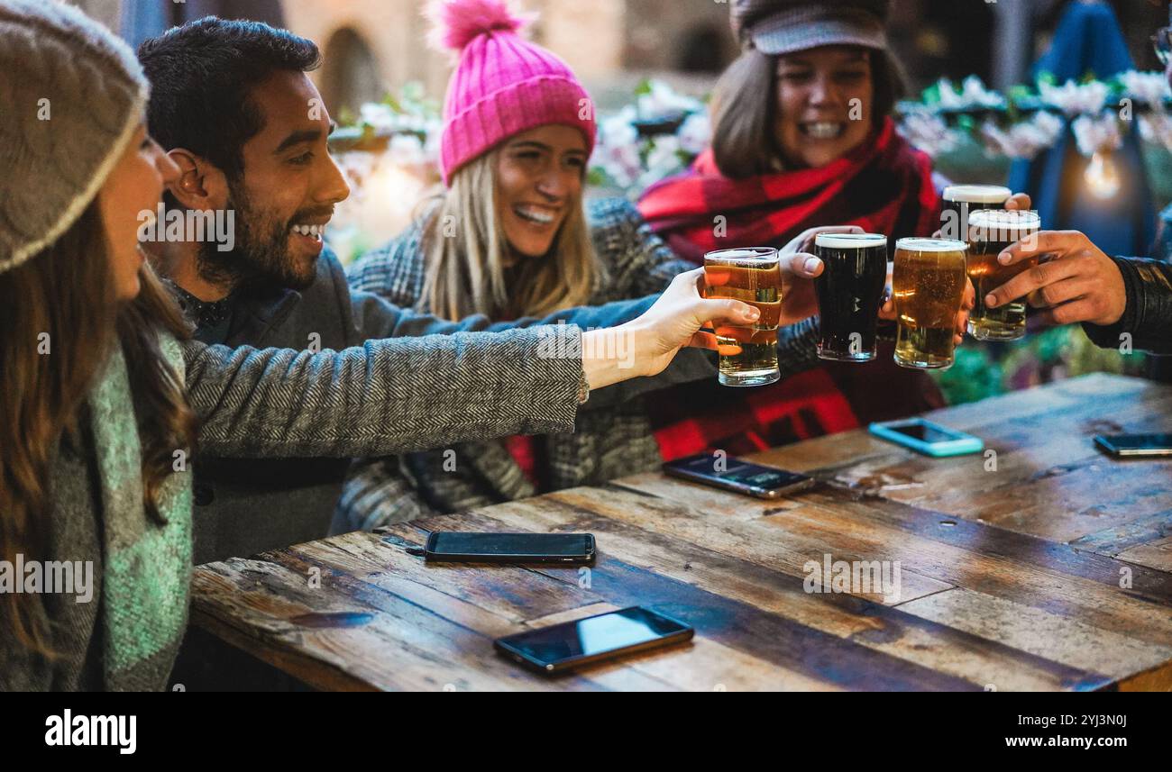Young friends having fun together drinking craft beers at pub ...