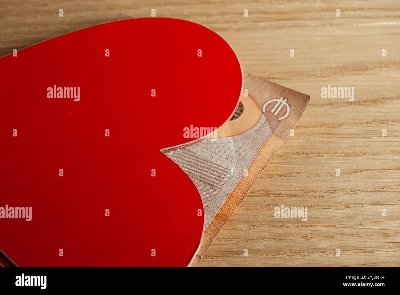 Red paper hearts with a money bill between them, symbolizing the ...