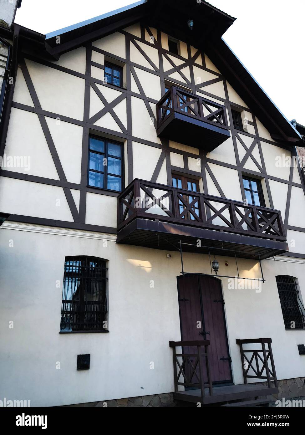 Front view of a traditional tudor style house featuring wooden ...