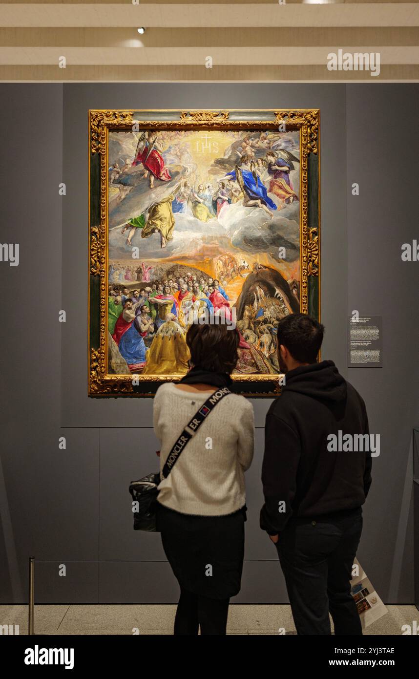 A couple admire Adoration of the Name of Jesus or Allegory of the Holy League, by El Greco, at ...