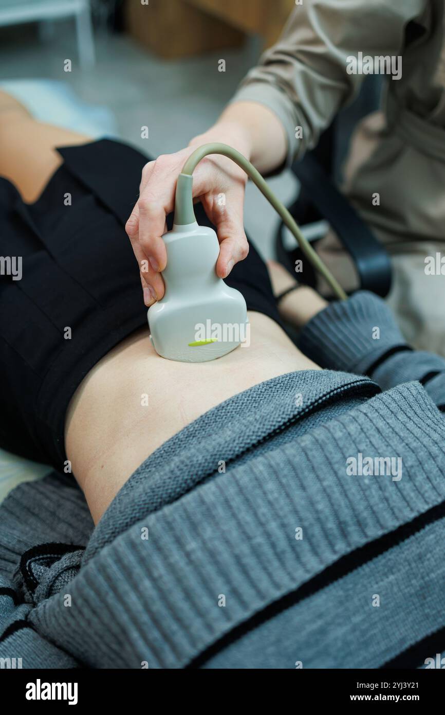 Examination using an ultrasound machine at work. Modern clinical ...
