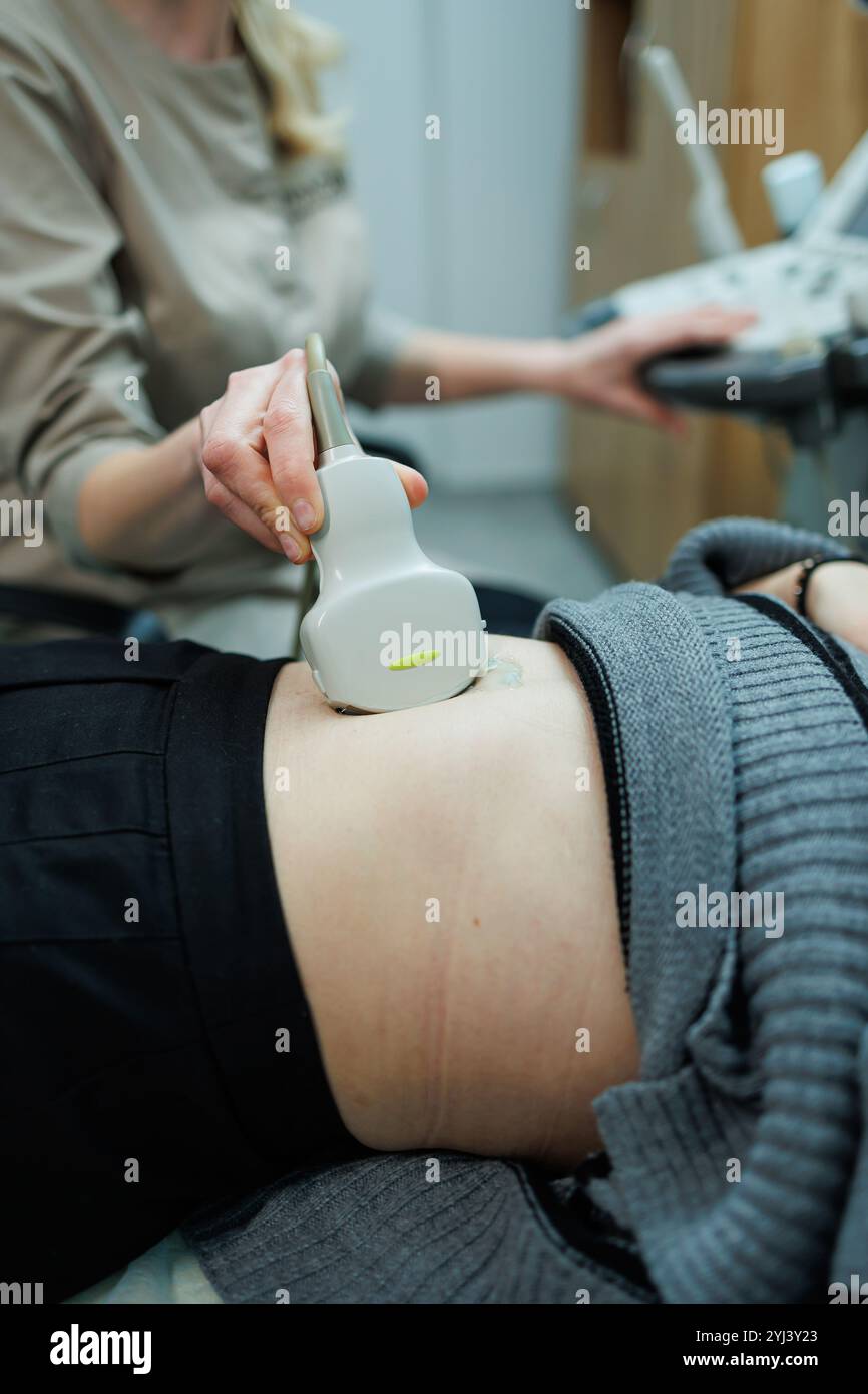 Examination using an ultrasound machine at work. Modern clinical ...
