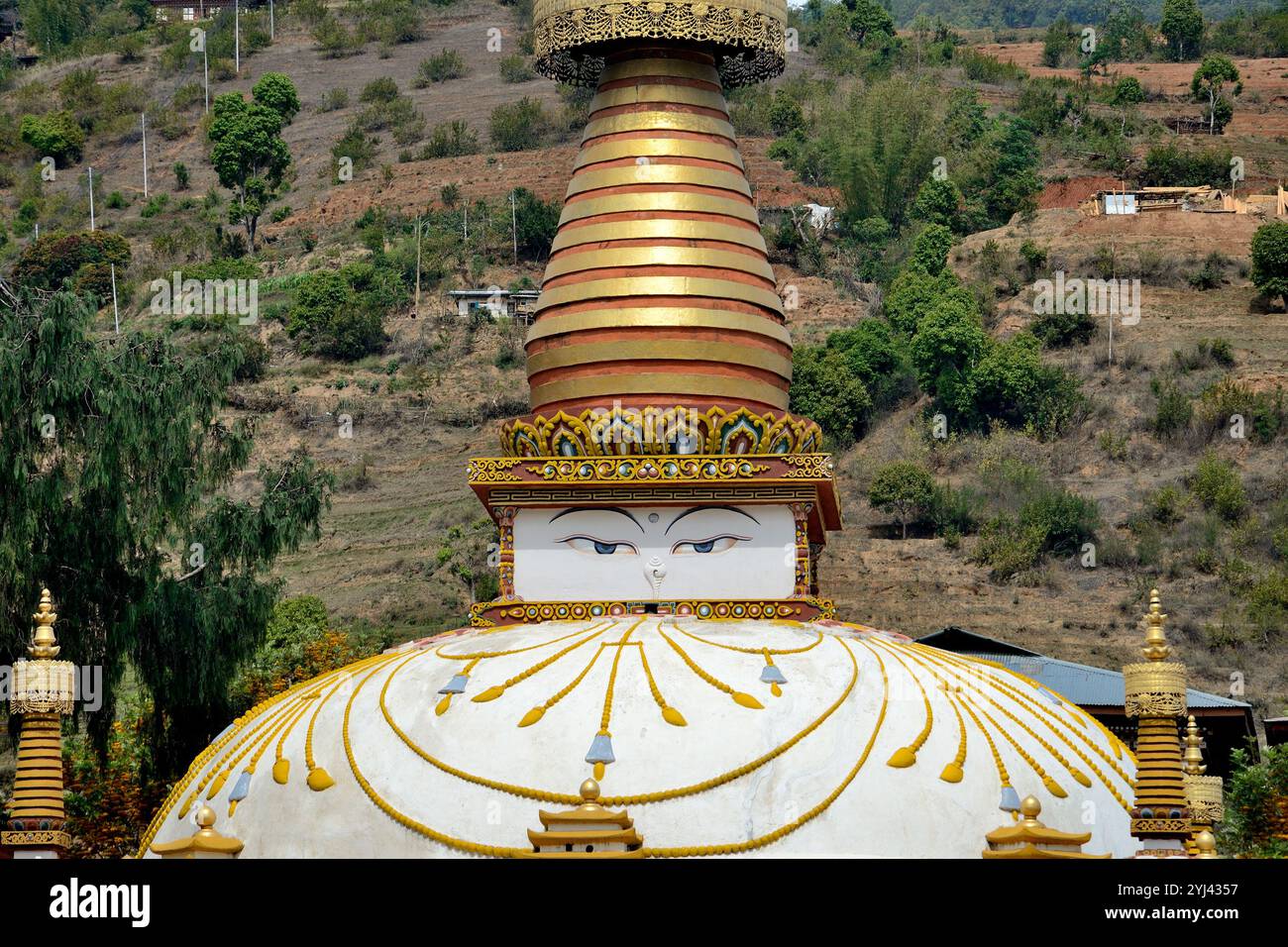 Colorful small chorten with eyes painted on it, on the way to dzong ...