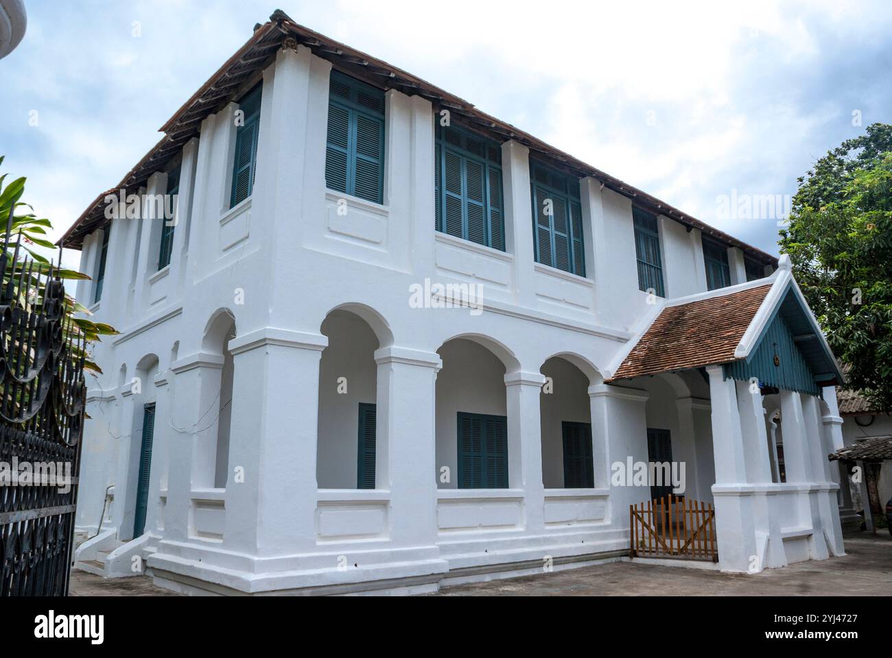 Exterior of an old white mansion in French colonial style in Luang ...