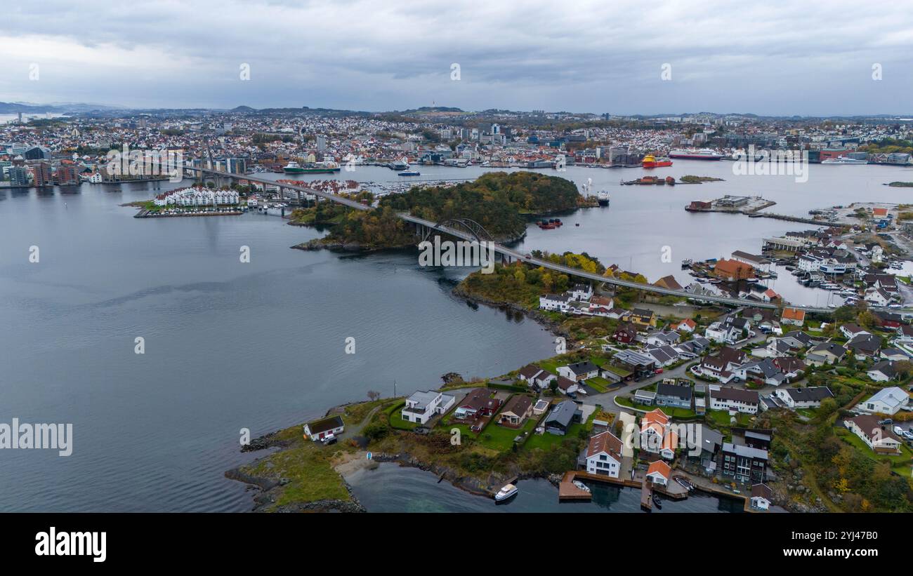 Aerial view of a coastal city with a bridge connecting two land areas ...