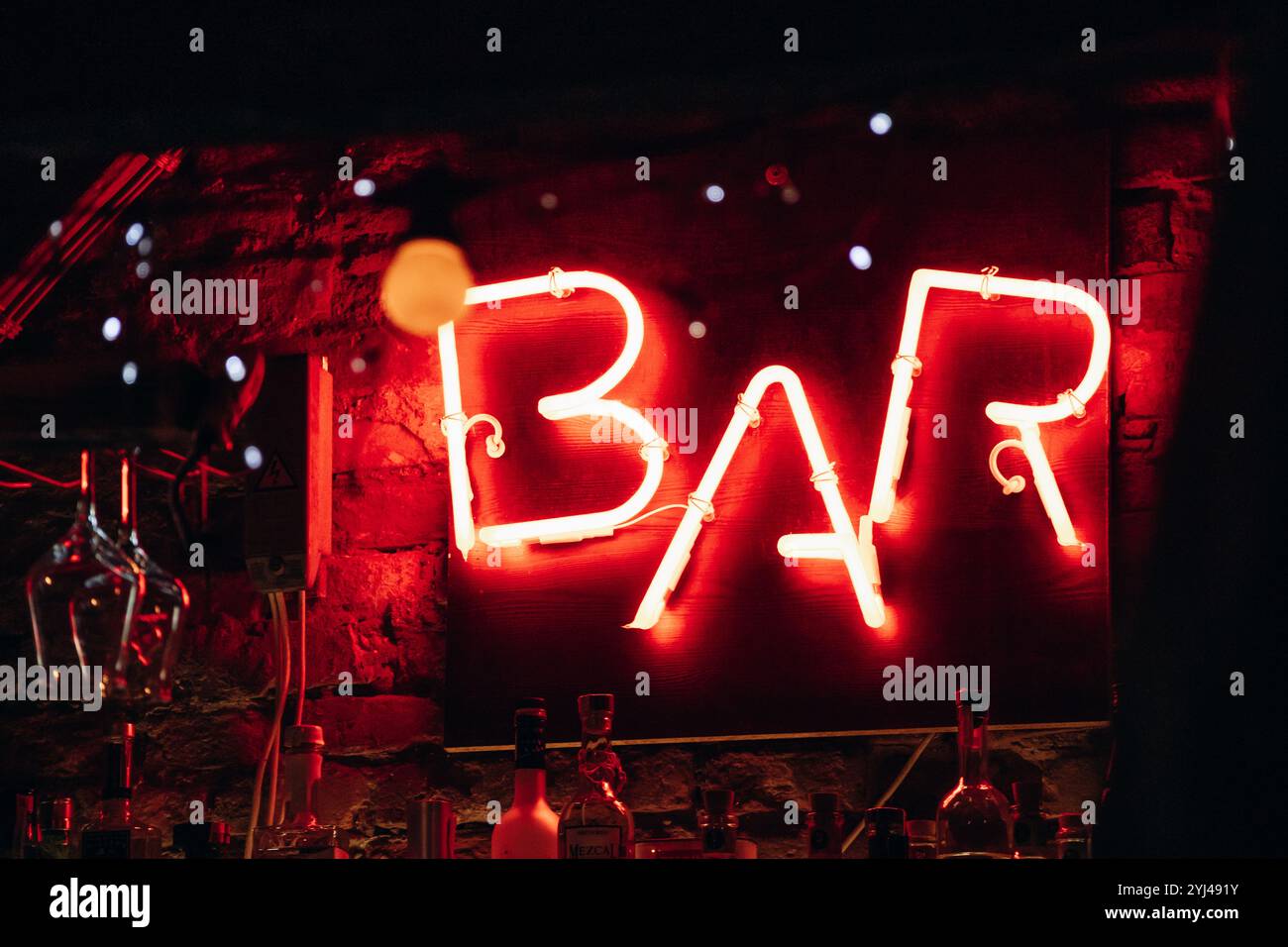 Neon red sign "Bar" in a bar Stock Photo - Alamy