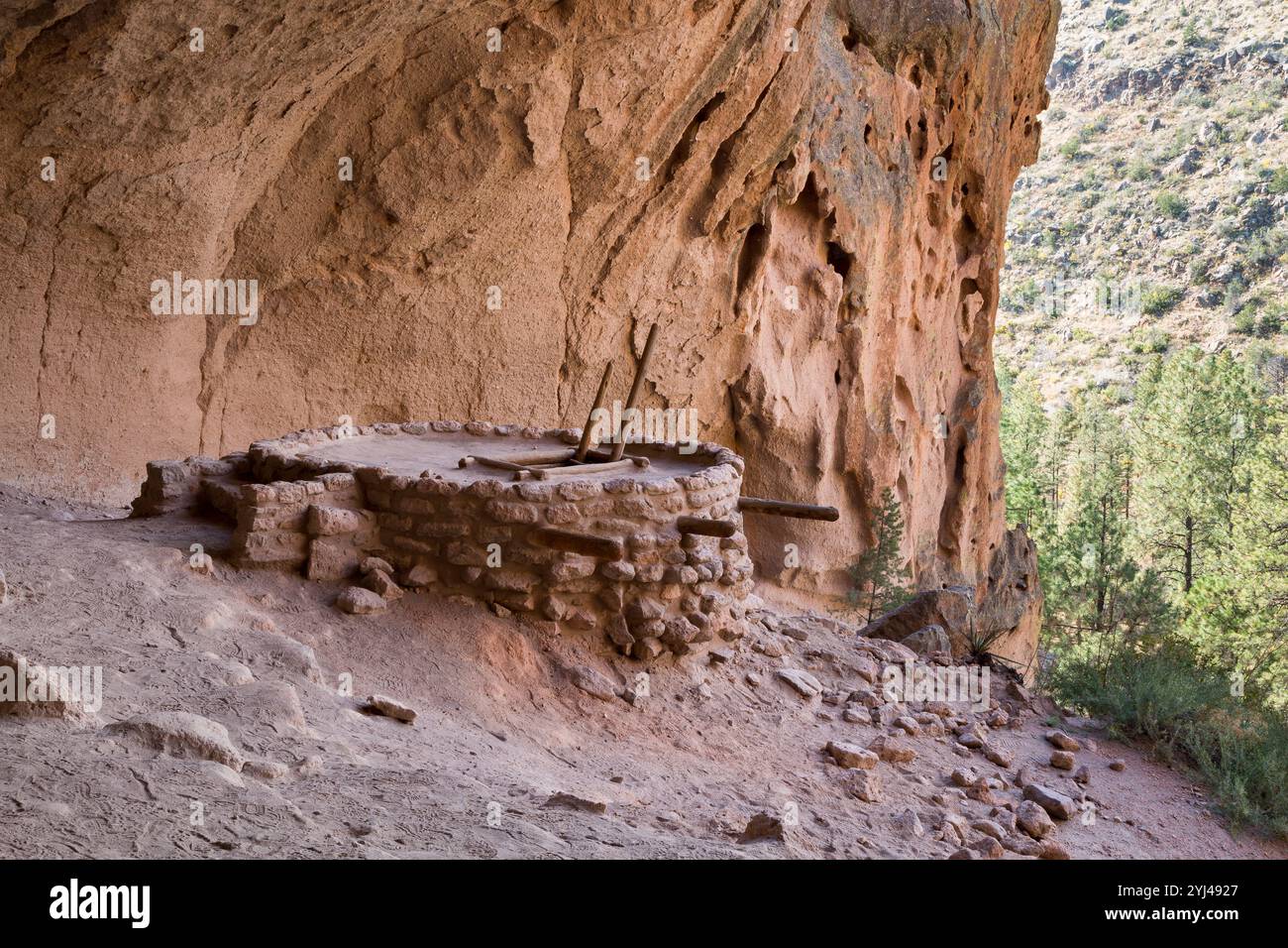 The historic Alcove House resting below large tuff cliffs above ...