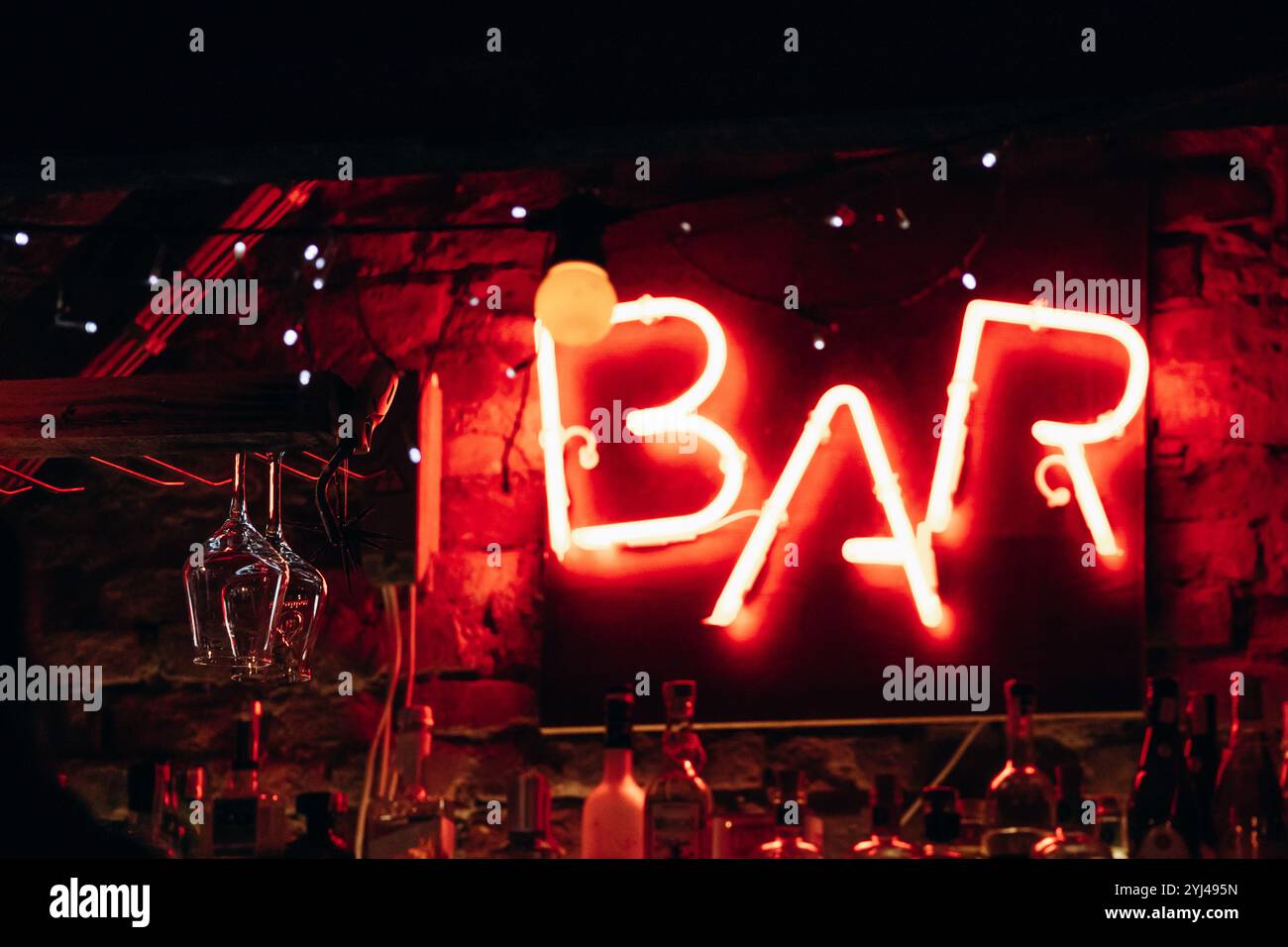 Neon red sign "Bar" in a bar Stock Photo - Alamy