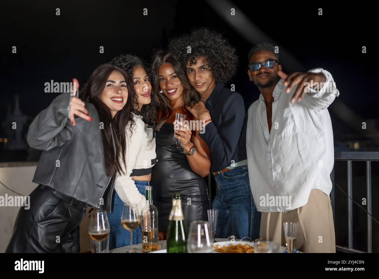 Frontal portrait of a group of multi-ethnic friends gesturing to be ...