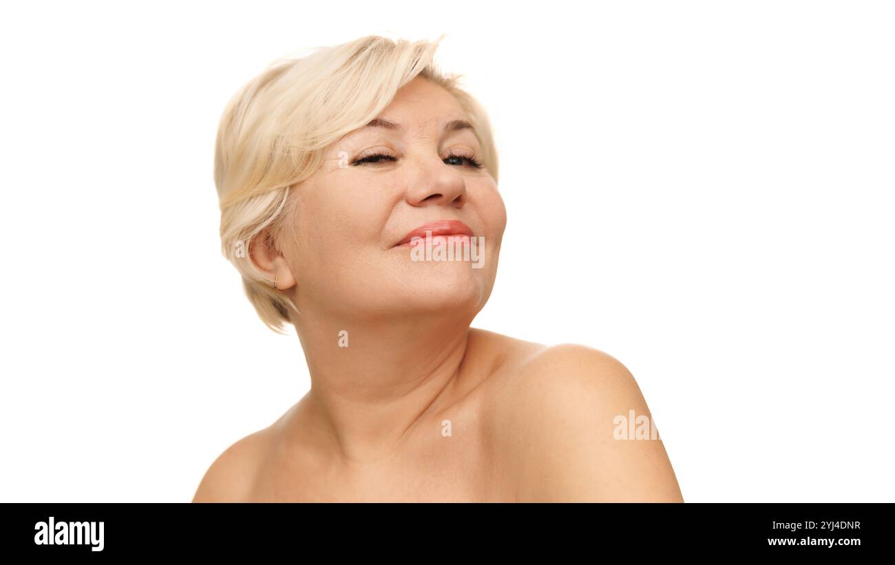 Mature woman with cheerful, light smile and clear complexion ...