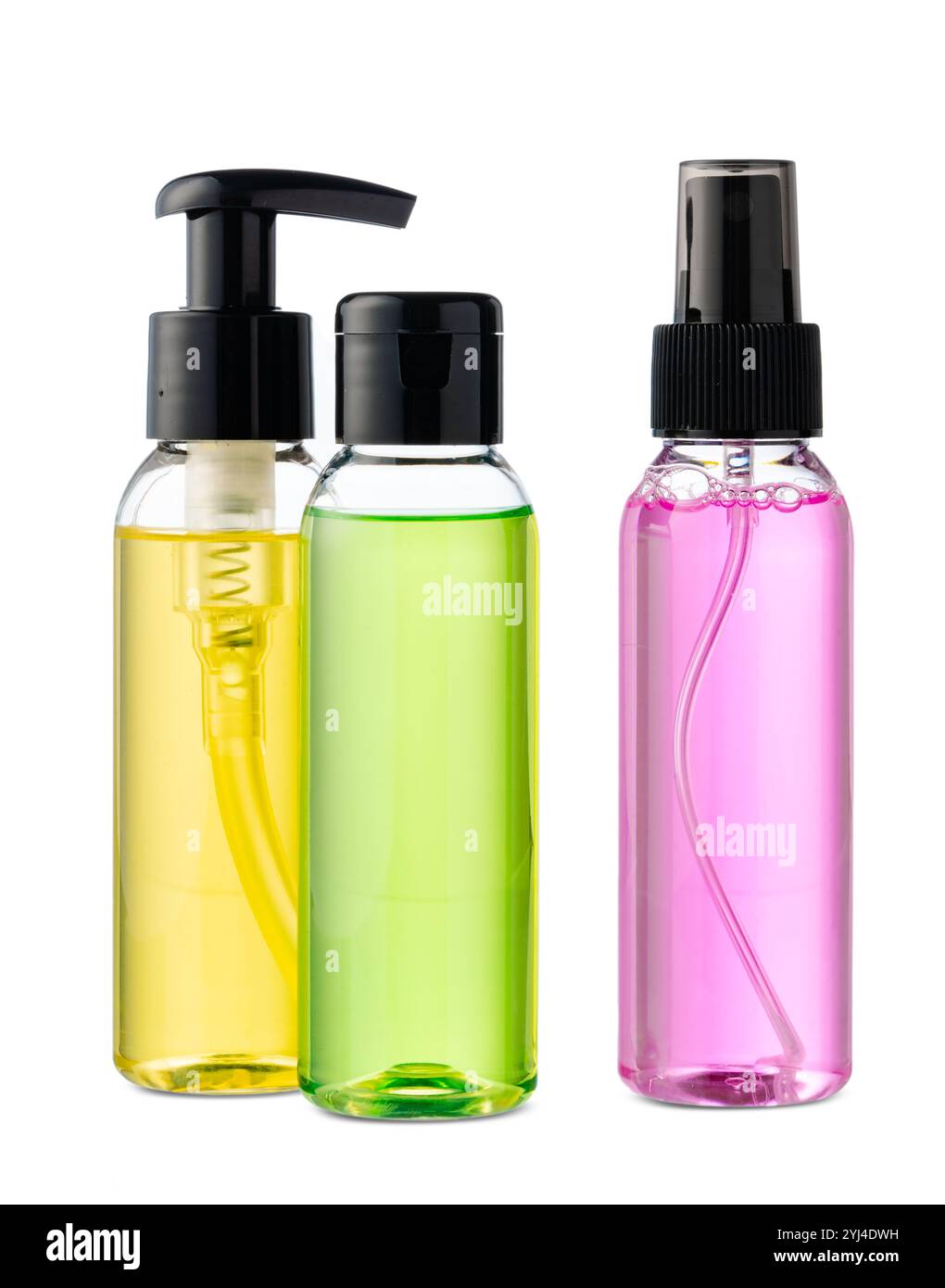 Various bottles with colored liquids and pumps arranged on white ...