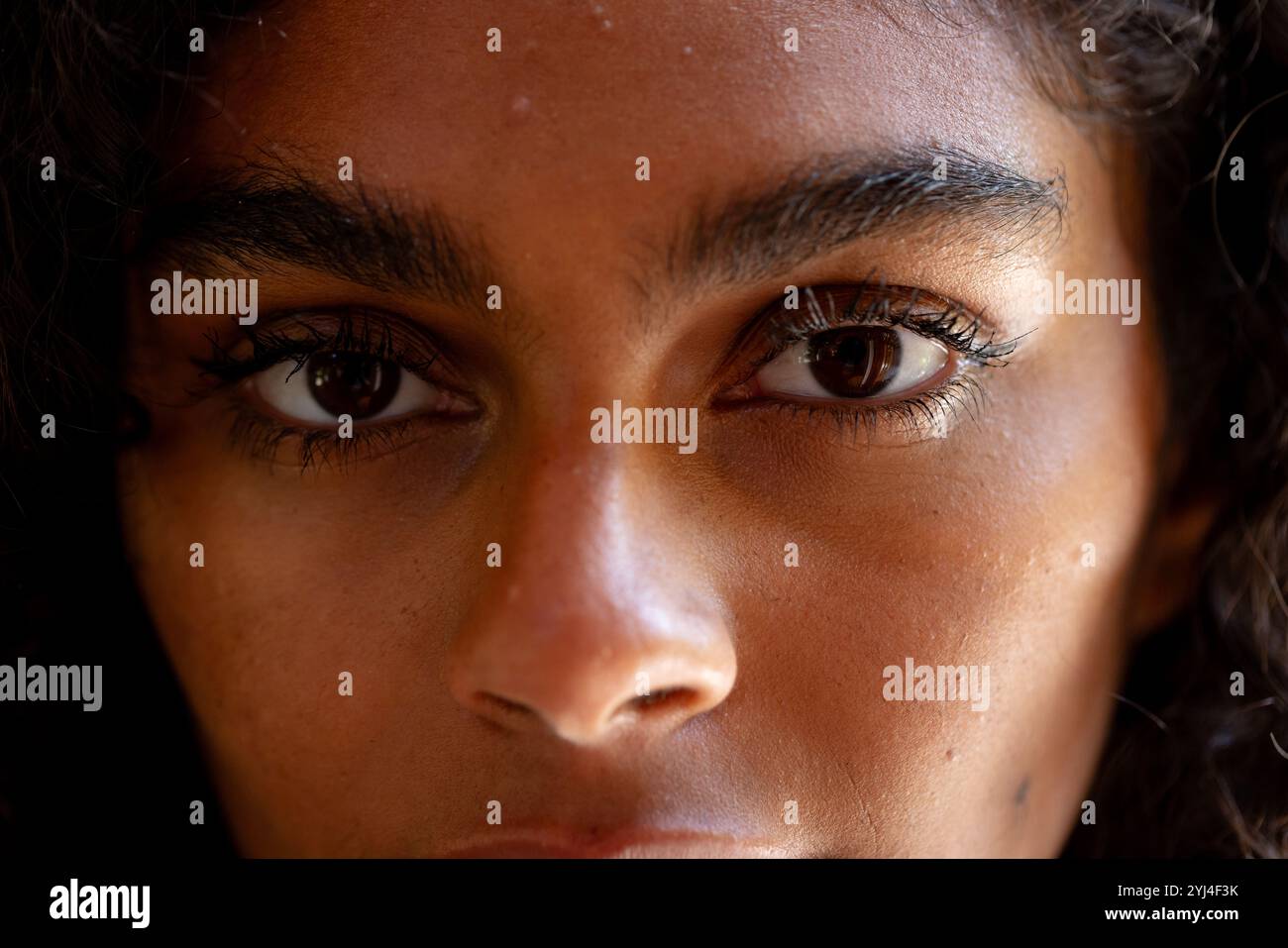 Close-up of woman's eyes showing thoughtful expression in natural light ...
