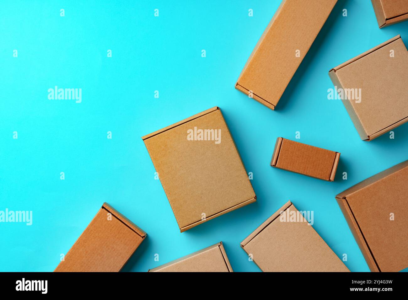 A collection of cardboard boxes arranged on a bright blue surface Stock ...