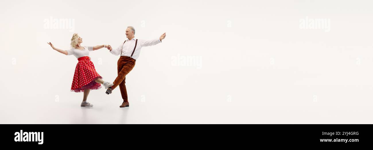Senior couple, stylish man in suspenders and elegant woman in polka dot ...