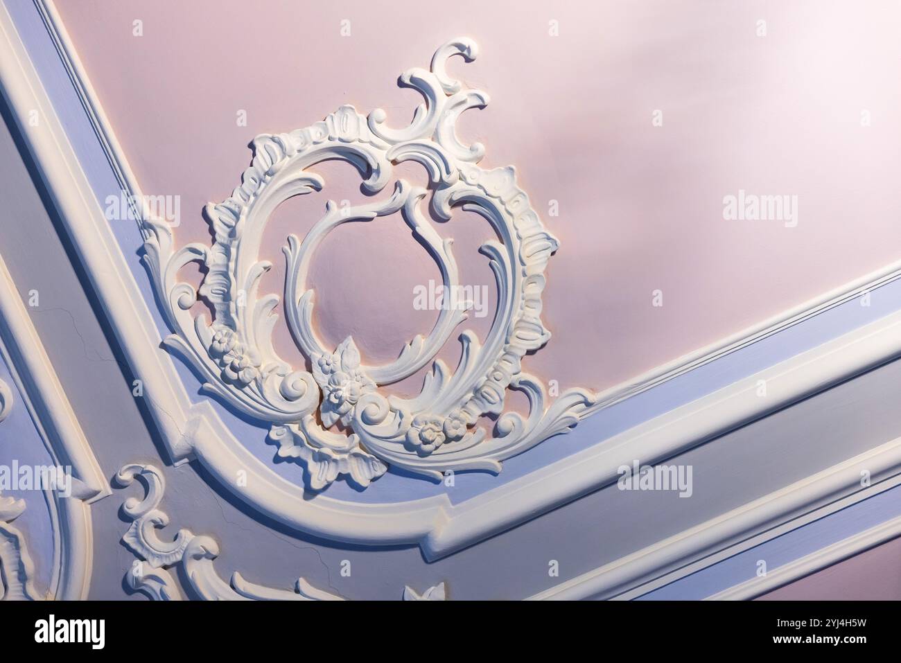 White bas-relief decoration details over blue pink ceiling background ...