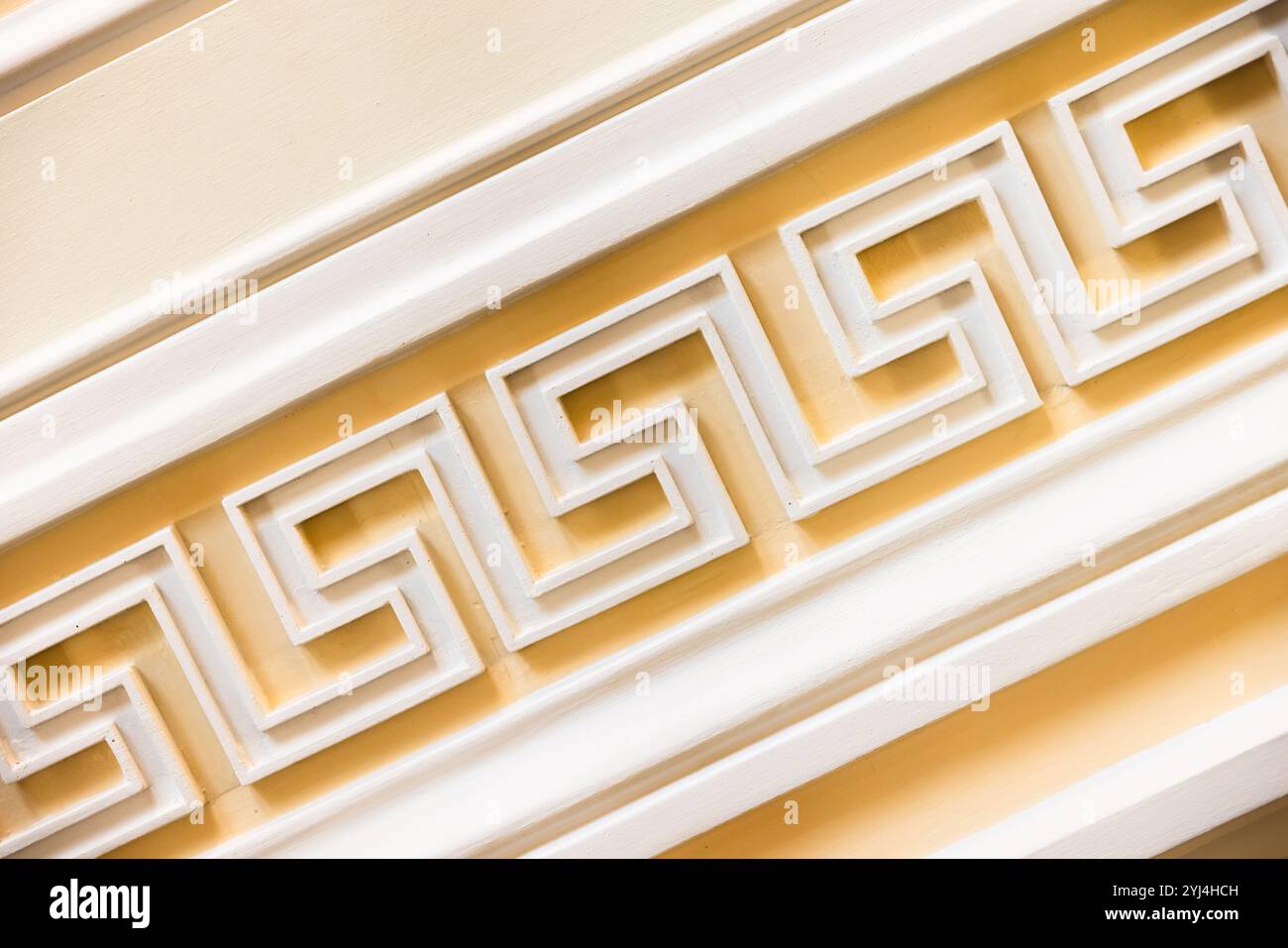 Wall decoration with white Meander motif over yellow backdrop, classic ...