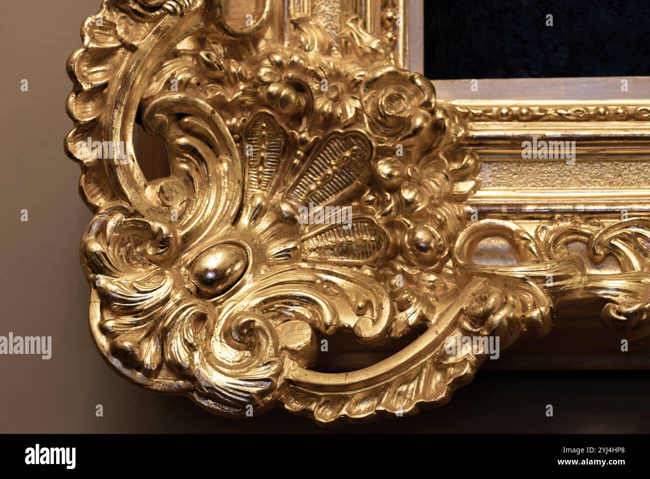 Corner decoration of a vintage golden frame, wooden carving details ...