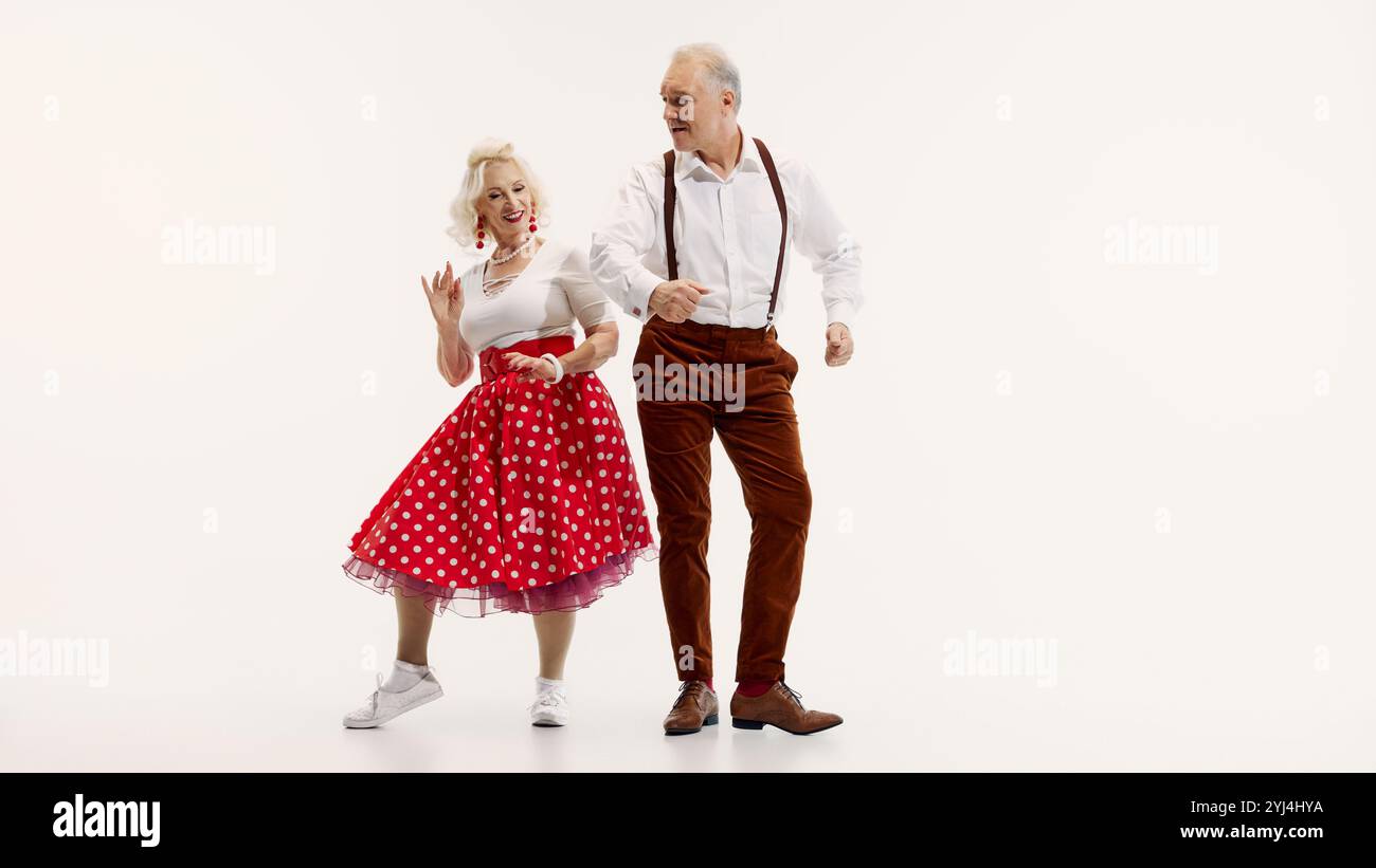Elderly couple dancing together with smiles and enthusiasm isolated on ...